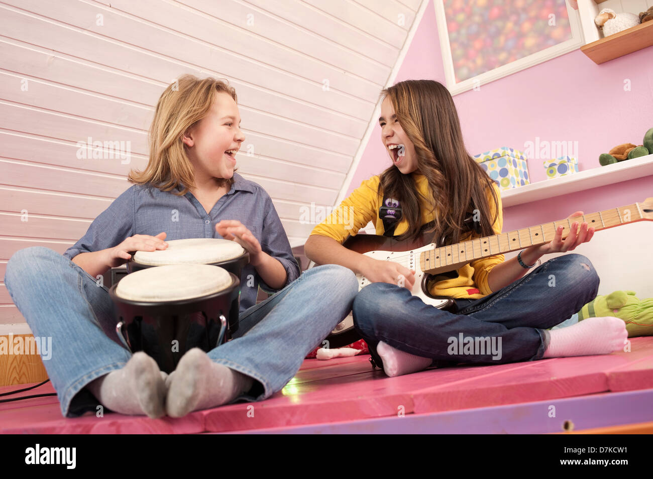 Girls playing guitar and drums, laughing Stock Photo - Alamy
