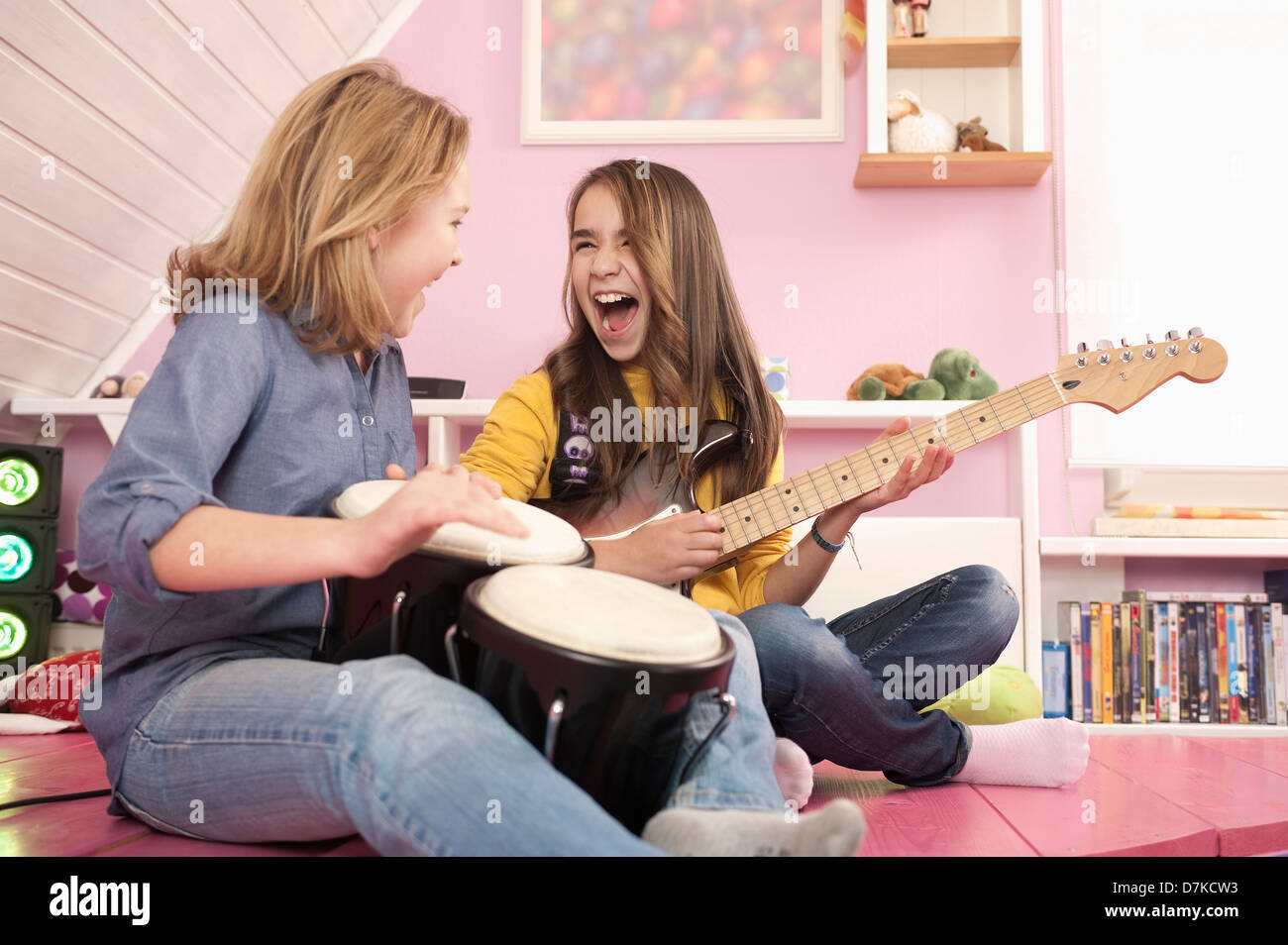 Girls playing guitar and drums, laughing Stock Photo - Alamy