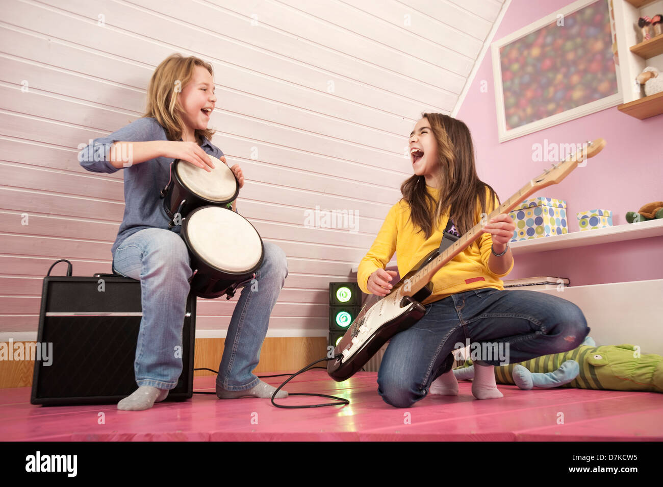 Girls playing guitar and drums, laughing Stock Photo - Alamy