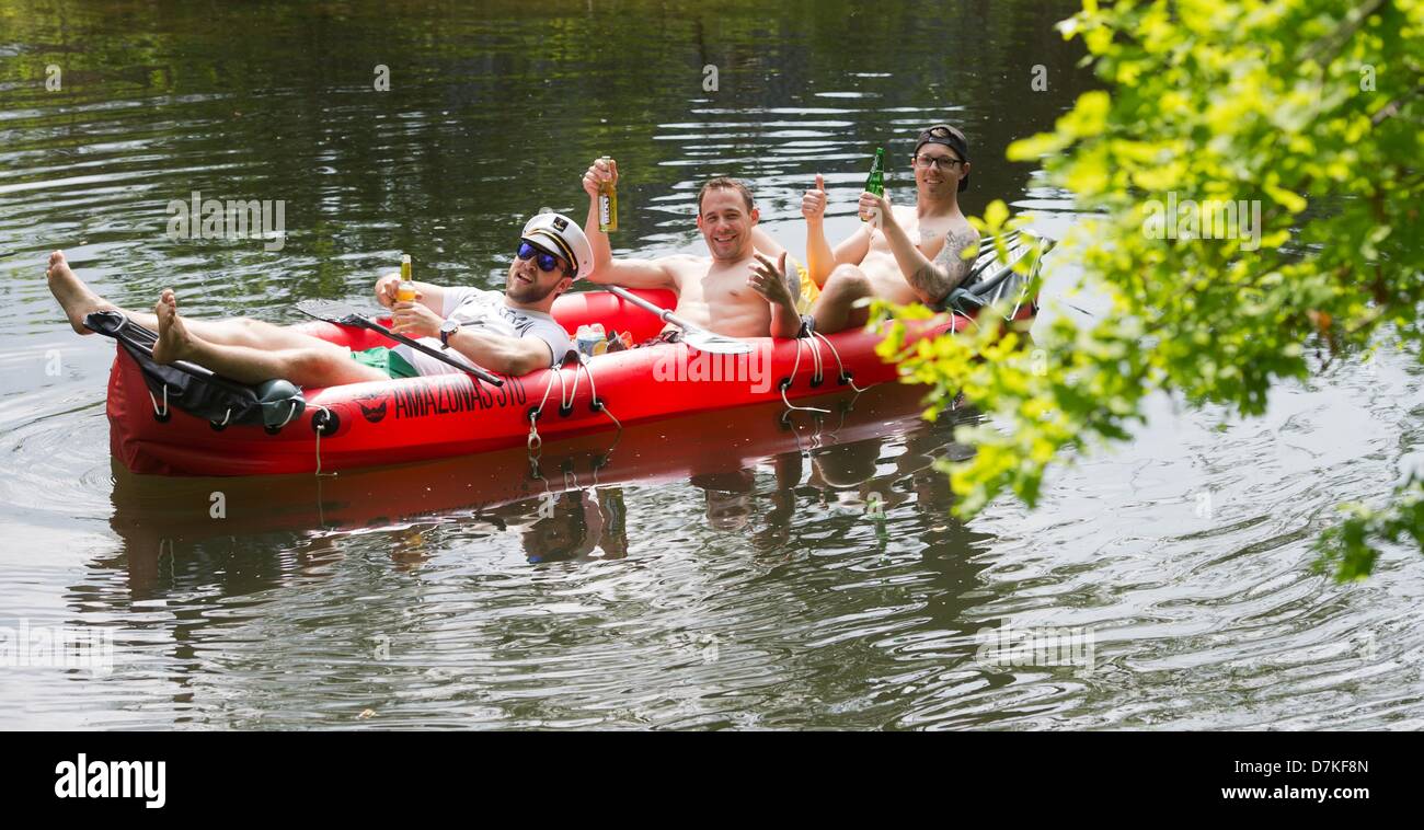 Men celebrating Father's Day float down the Leine River in an ...