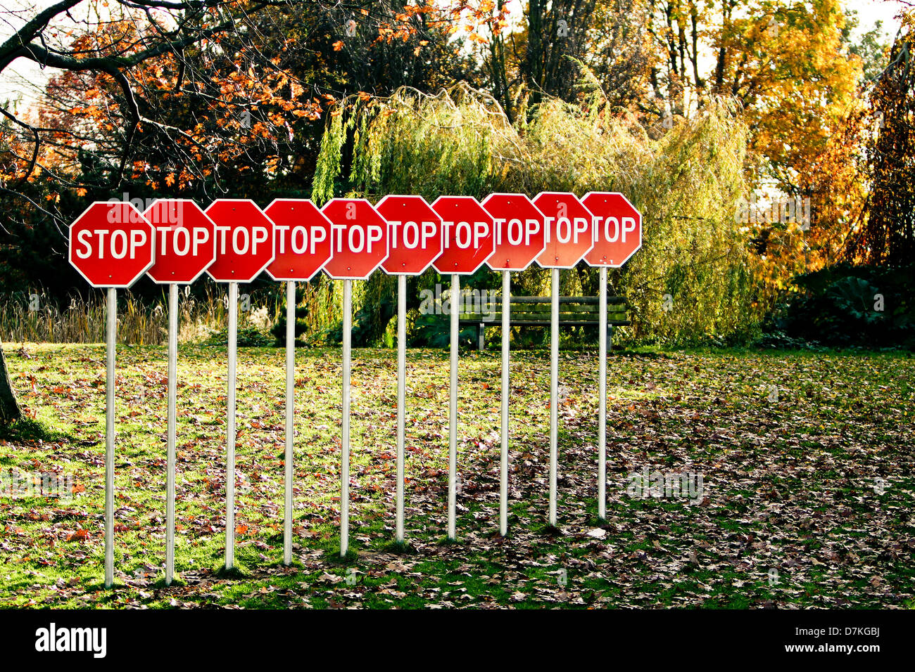 10 stop signs as an art display at a park with trees and nature Stock ...