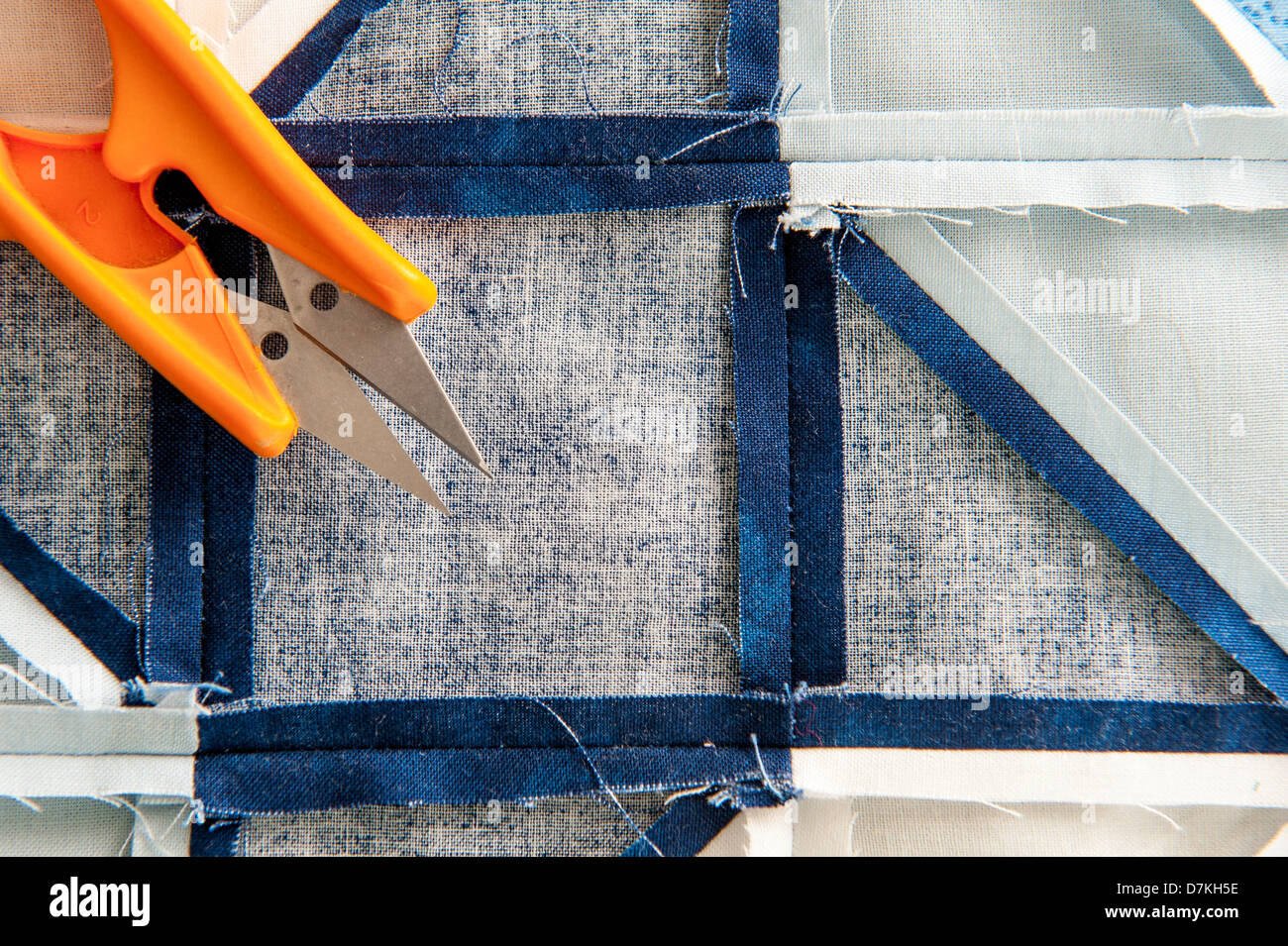 Quilting or patchwork materials and tools with scissors showing blue ...