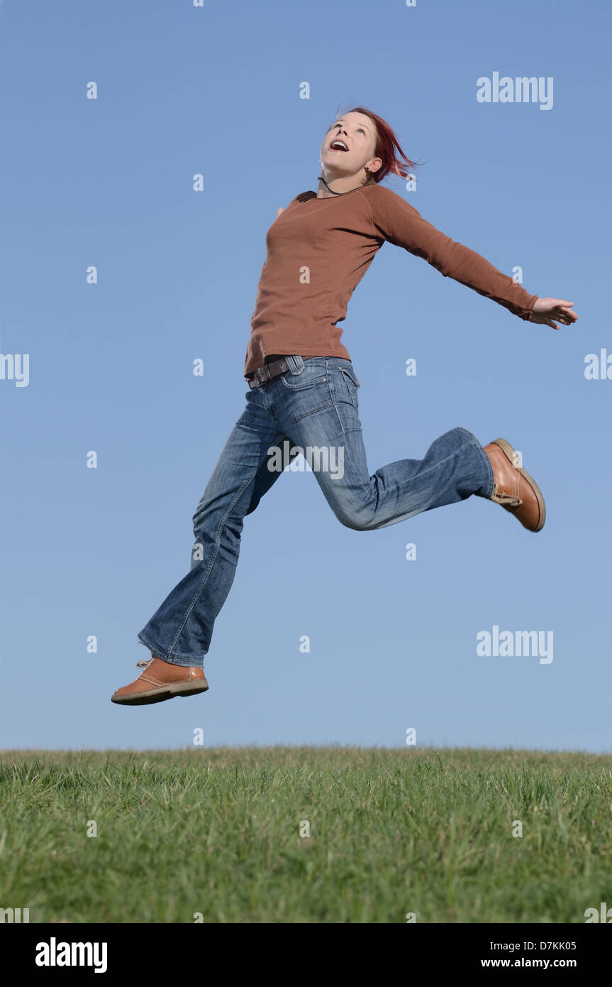 Woman making a happy jump Stock Photo - Alamy