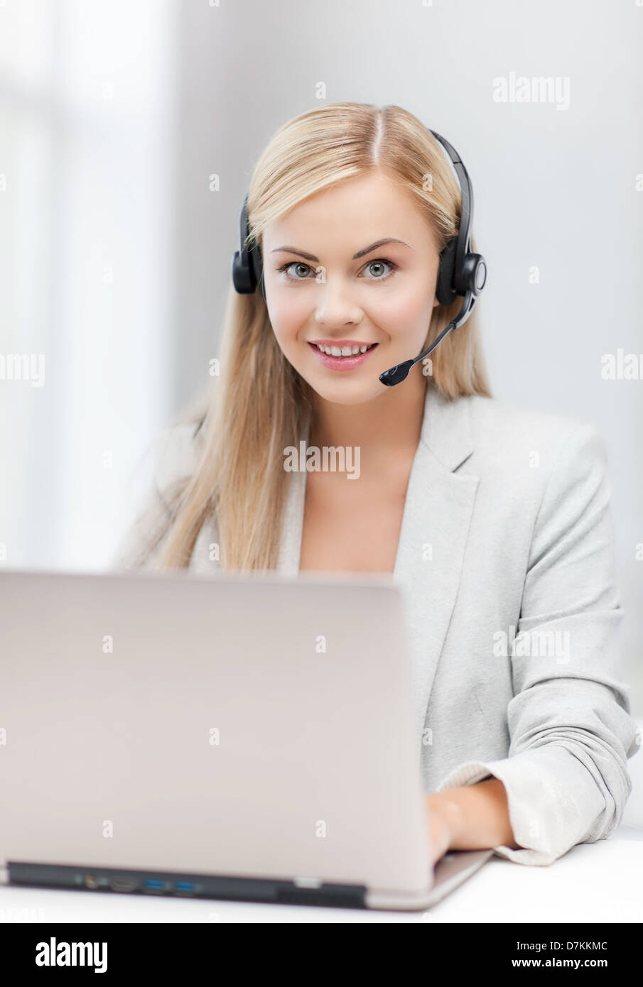 friendly female helpline operator with laptop Stock Photo - Alamy