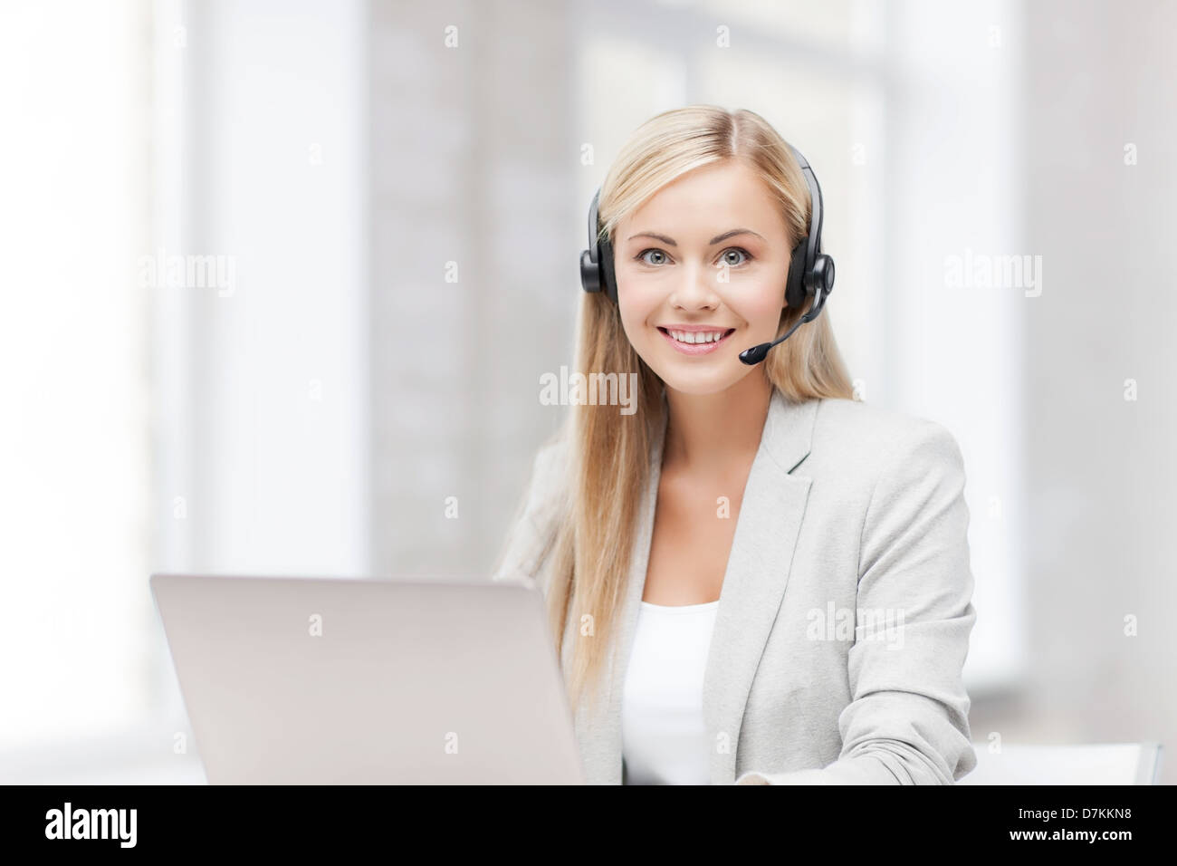 friendly female helpline operator with laptop Stock Photo - Alamy