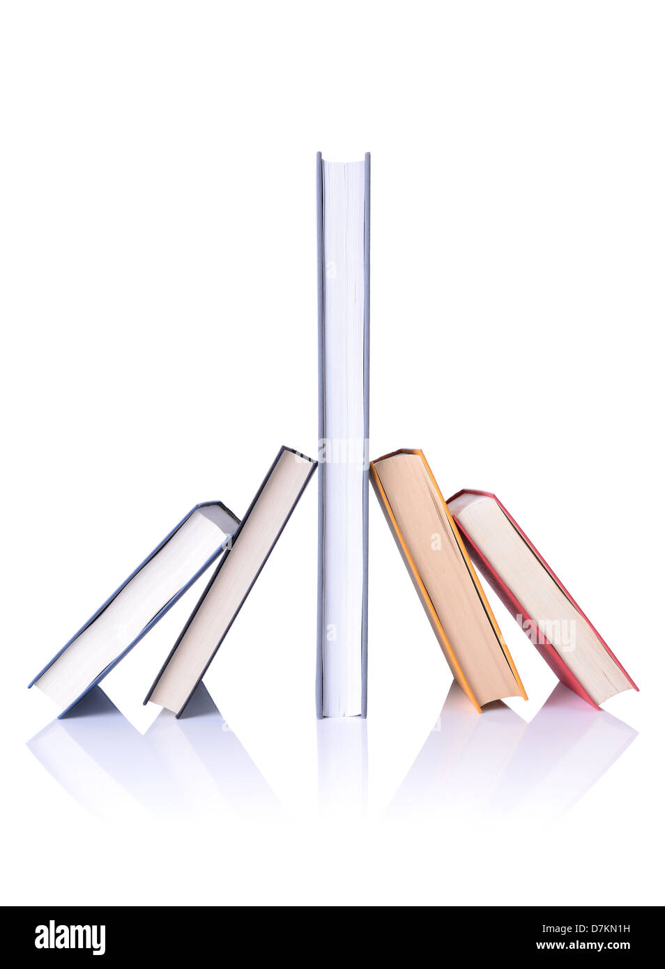 smaller books leaning on a larger book isolated on white Stock Photo ...