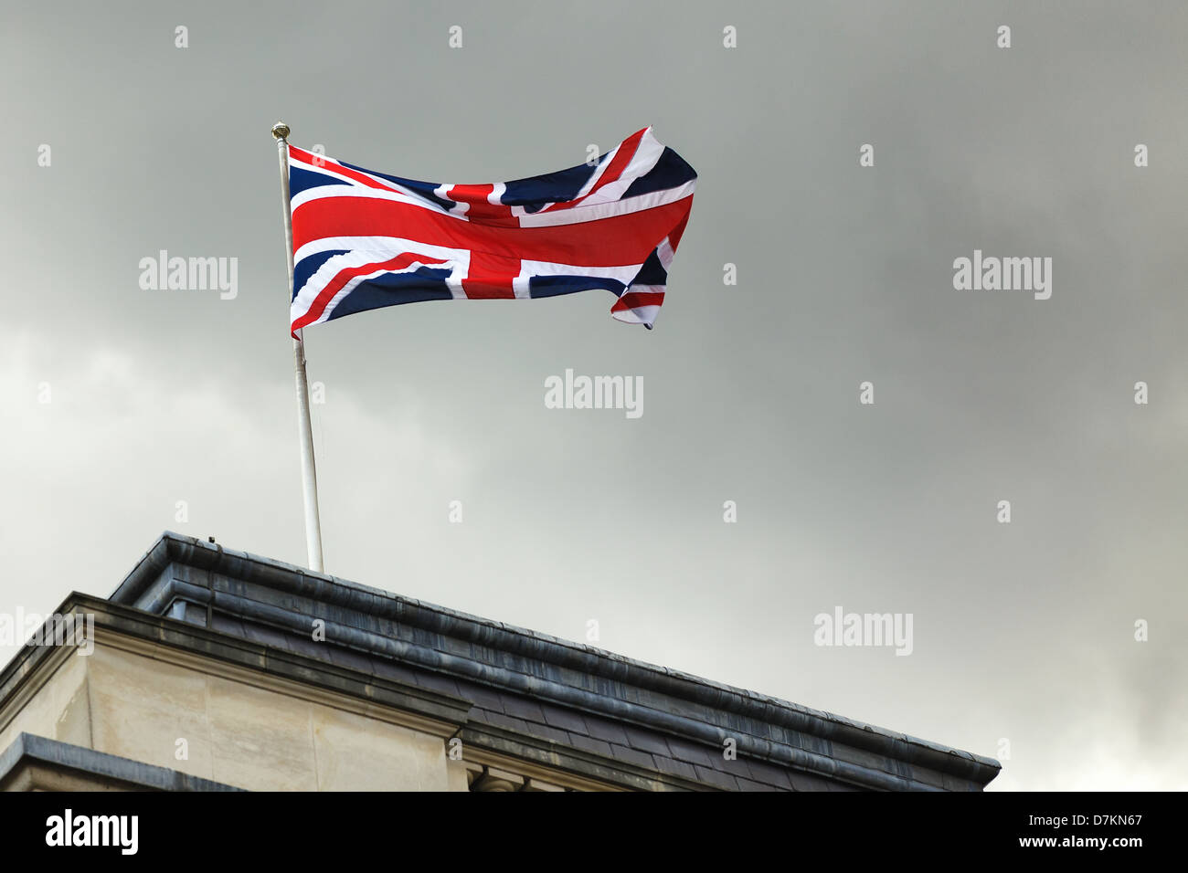 United Kingdom flag under windy and cloudy weather Stock Photo - Alamy