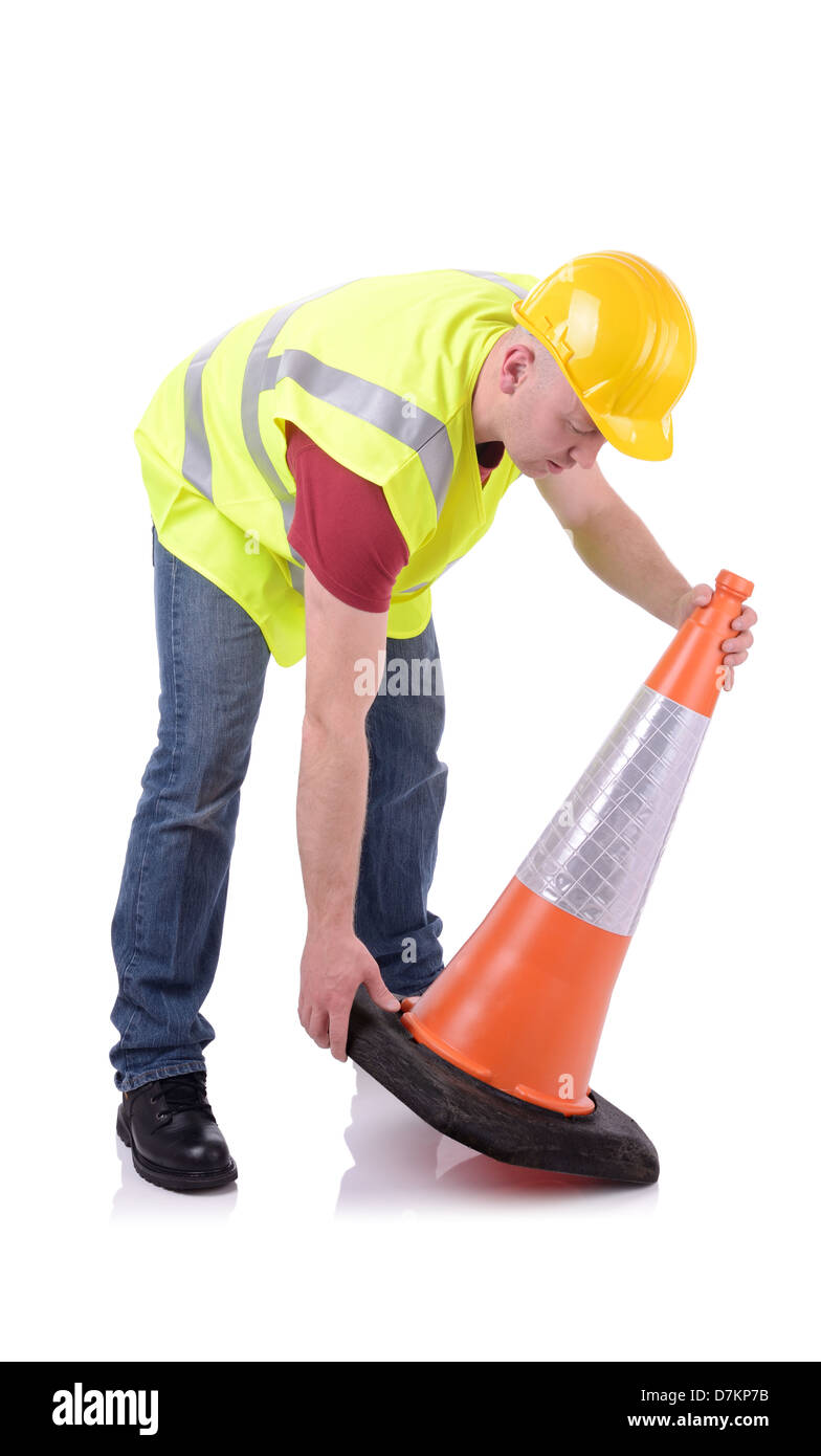 Construction worker setting out a traffic cone isolated on white Stock ...