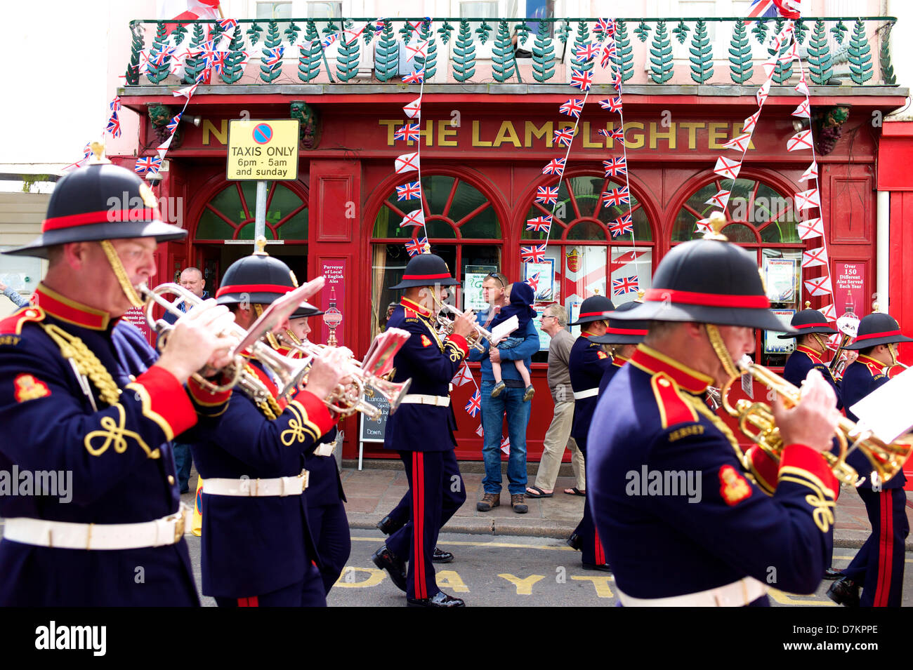 The band of the island of Jersey pass a Jersey pub during the ...