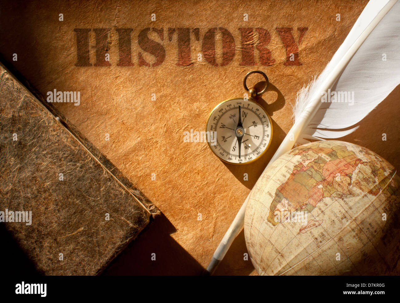 History etched on an old paper scroll with a feather quill and compass ...