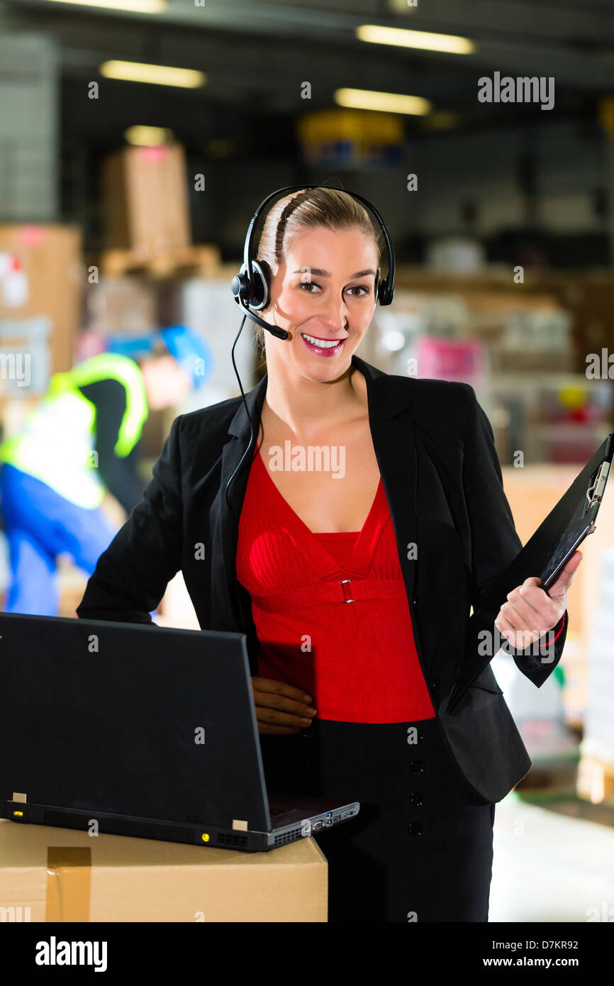 Friendly Woman, dispatcher or supervisor using headset and laptop at ...