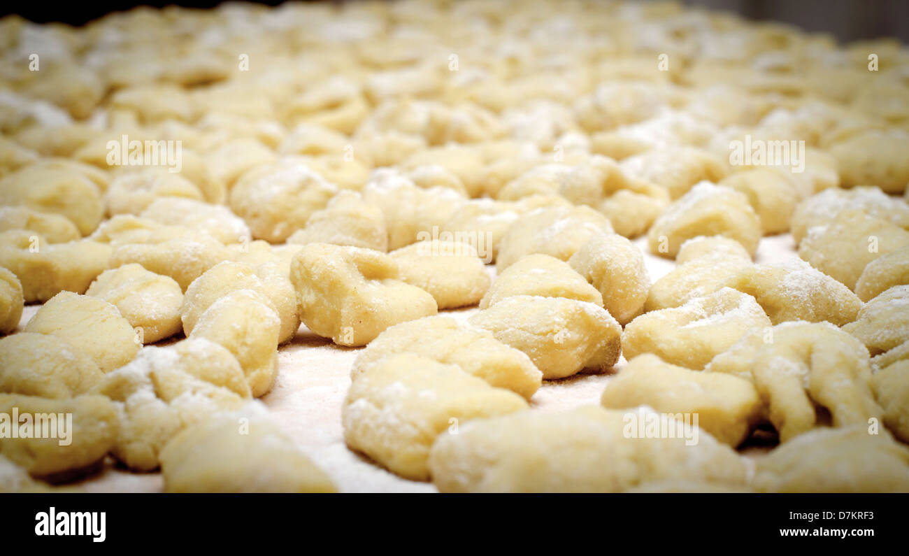 Lots of freshly prepared handmade italian gnocchi, traditional pasta ...