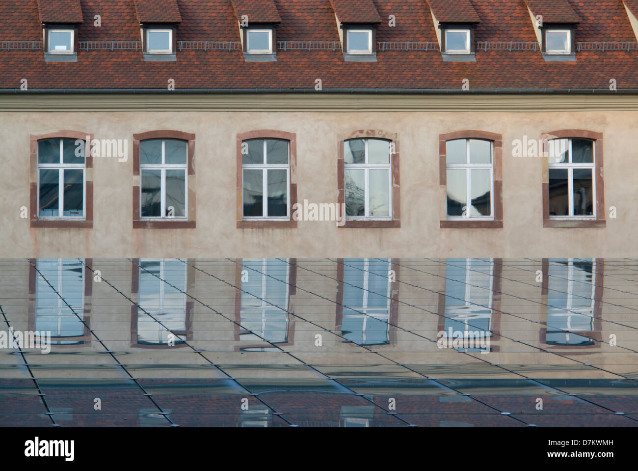 house facade with windows and modern reflective glass roof in front ...