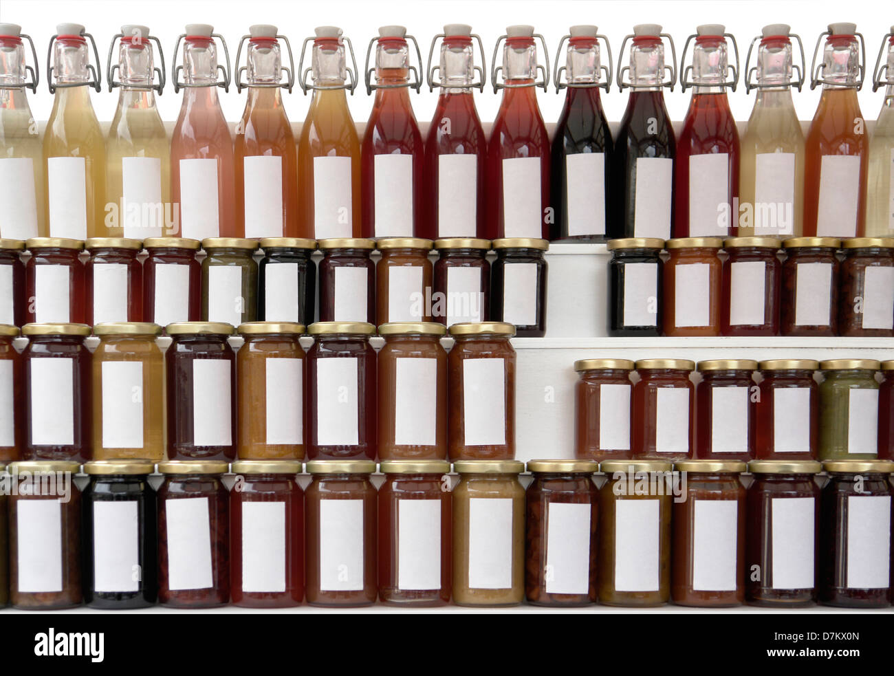 lots of preserving glasses and bottles filled with colorful content ...