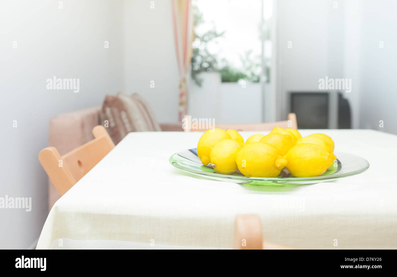 Modern and bright living room interior in house with lemons on table ...