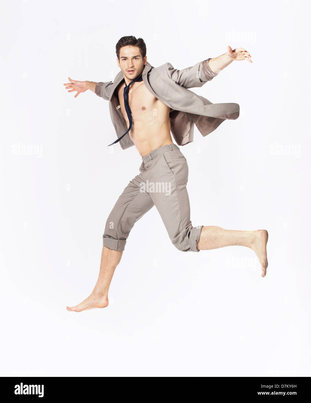 Handsome jumping guy on suit isolated on a white background Stock Photo ...