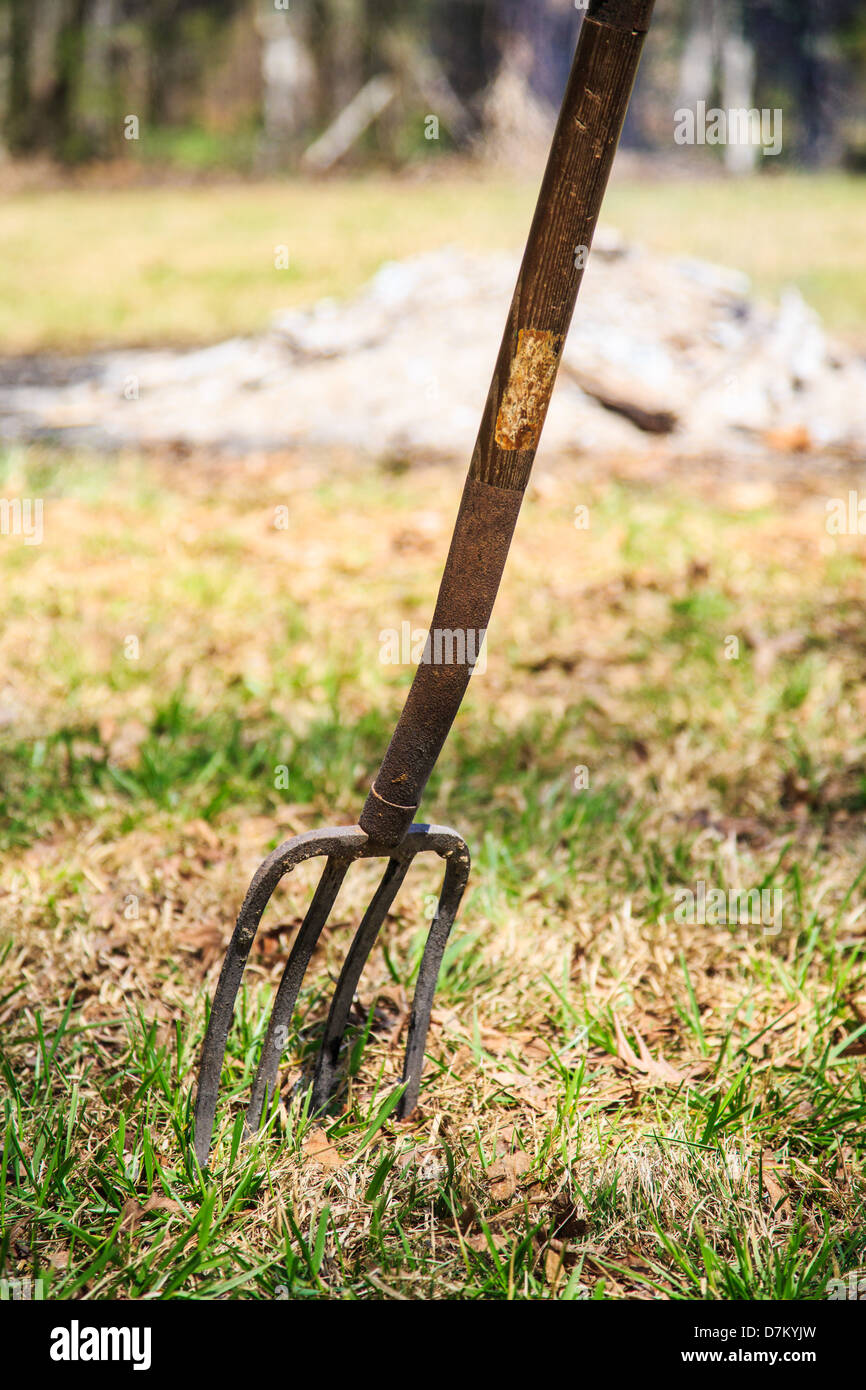 A pitch fork stands at the ready on a spring day at the farm Stock ...