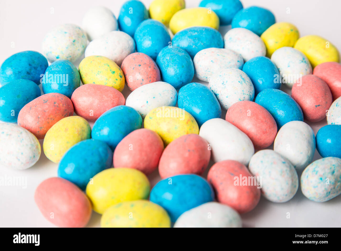 Easter Candy, chocolate eggs of various colors on a white background ...