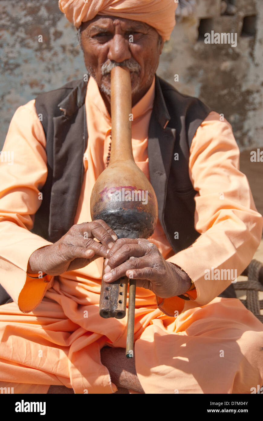 Deep in concentration a Sapera plays an ancient hypnotic tune on his ...