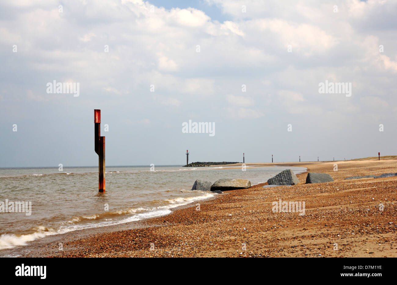 A rock breakwater and marker post on the beach at Eccles-on-Sea near ...