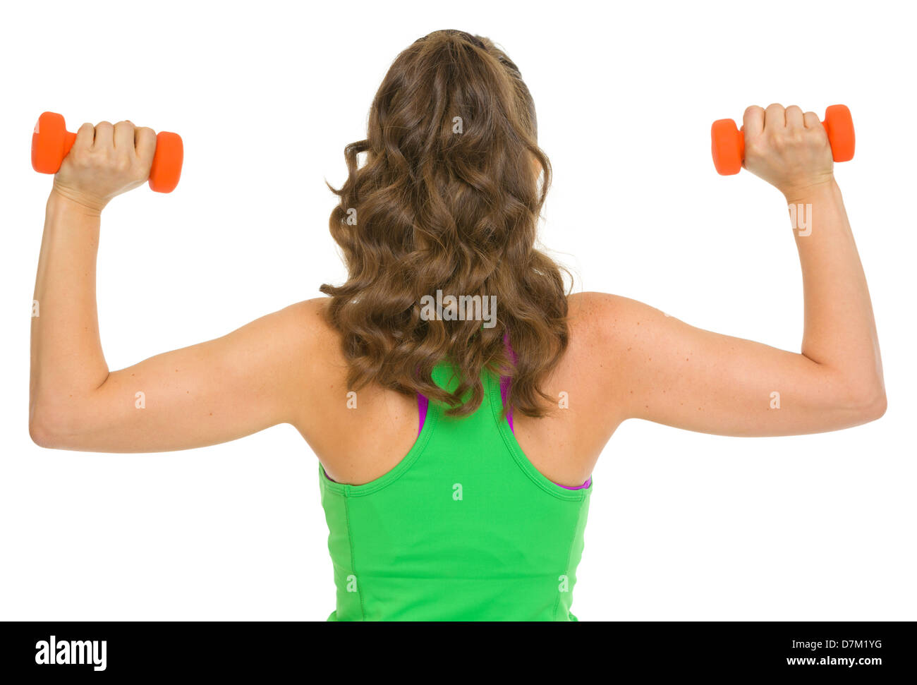 Slim woman making exercise with dumbbells . rear view Stock Photo - Alamy