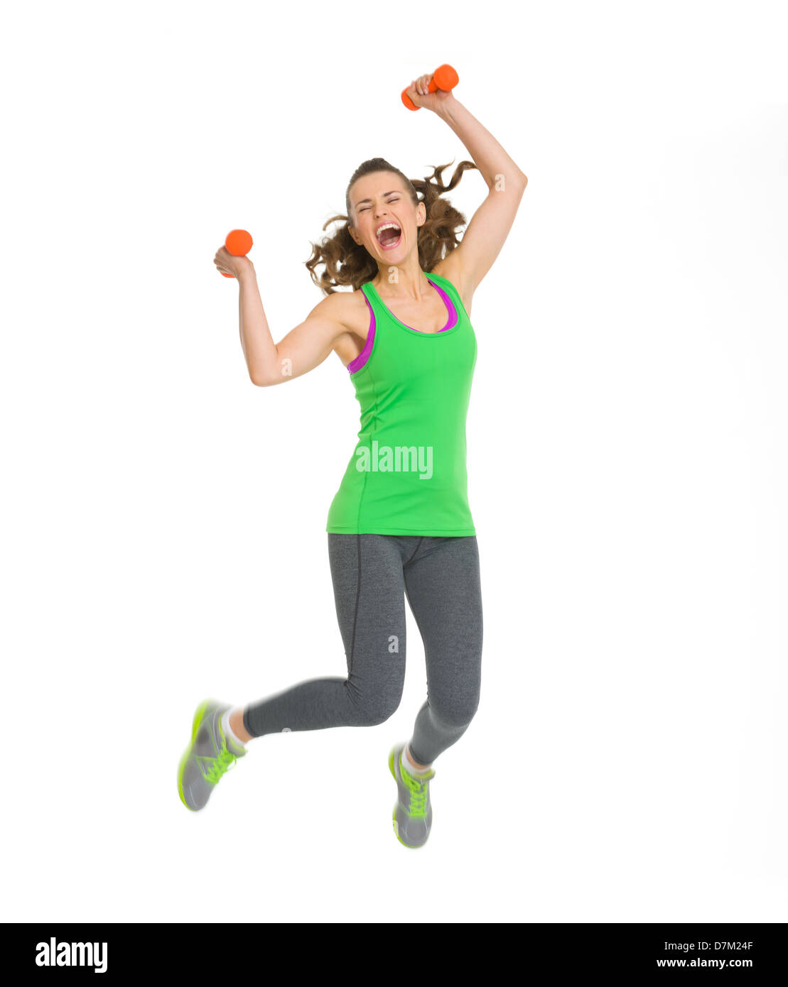 Happy fitness young woman with dumbbells jumping Stock Photo - Alamy