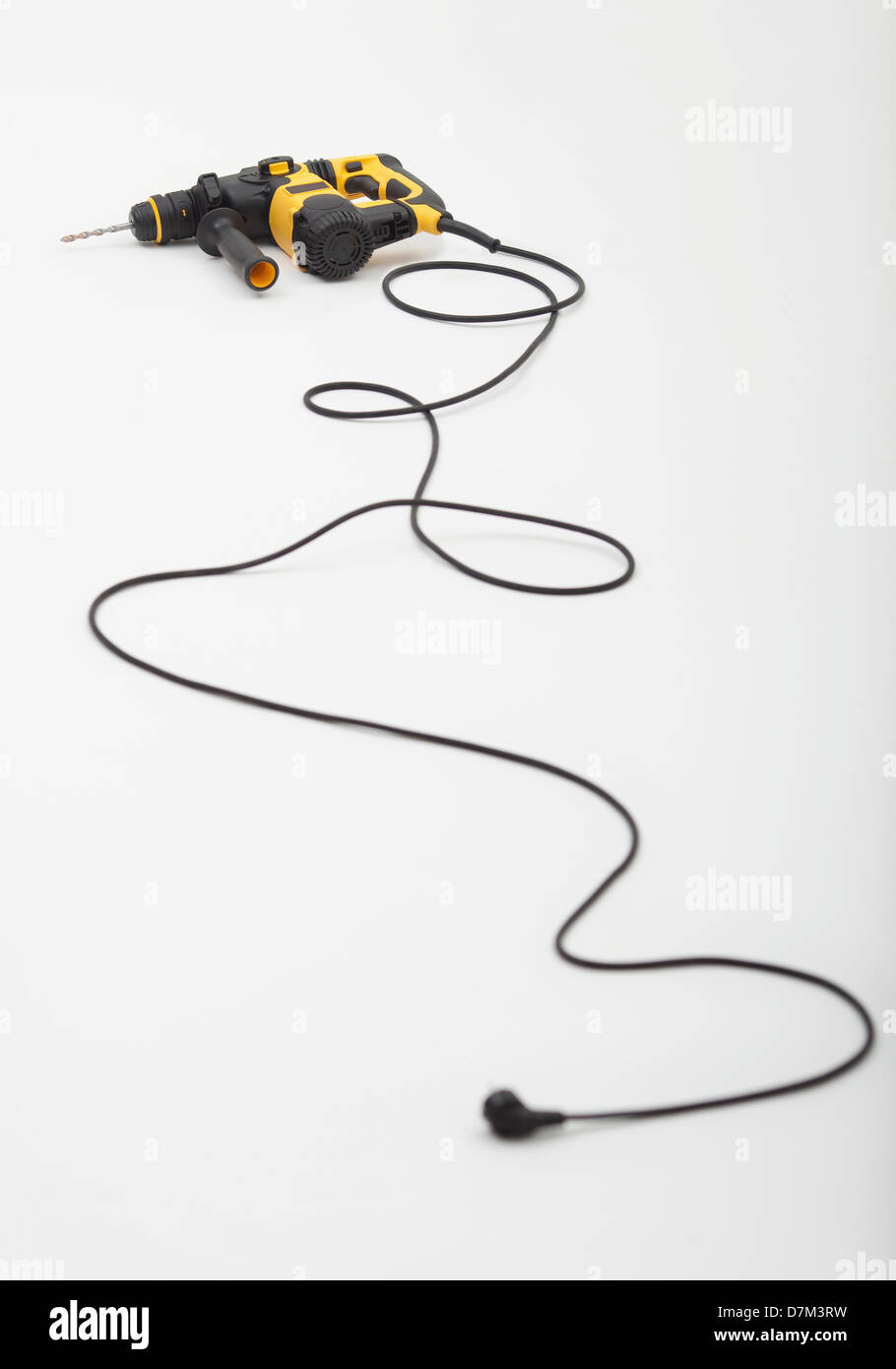 Power drill with long cable on white background Stock Photo - Alamy