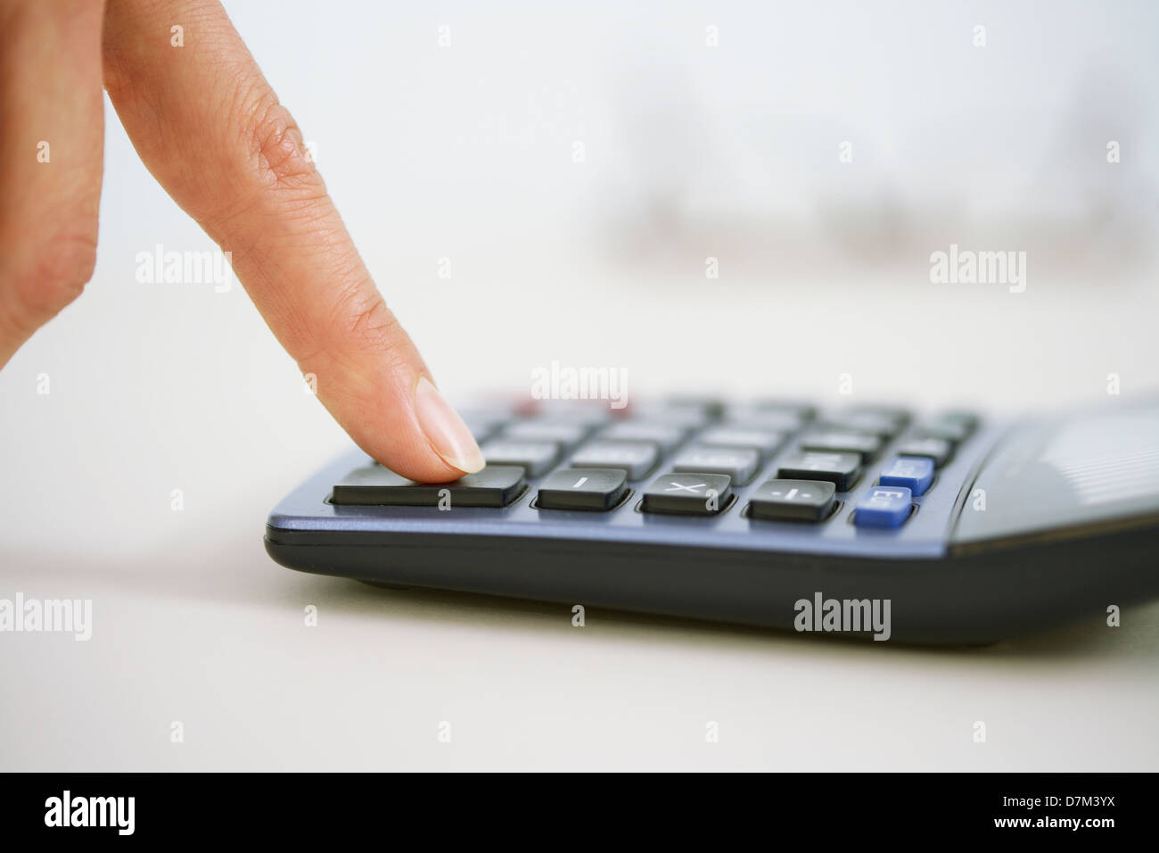 Human hand using calculator Stock Photo - Alamy