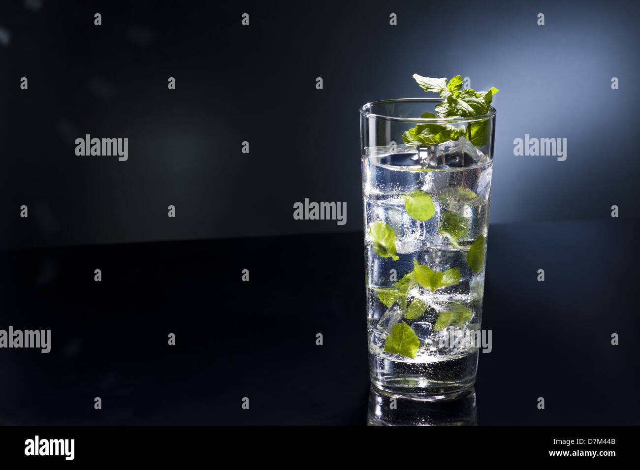 Green Mojito cocktail in disco light setting Stock Photo - Alamy