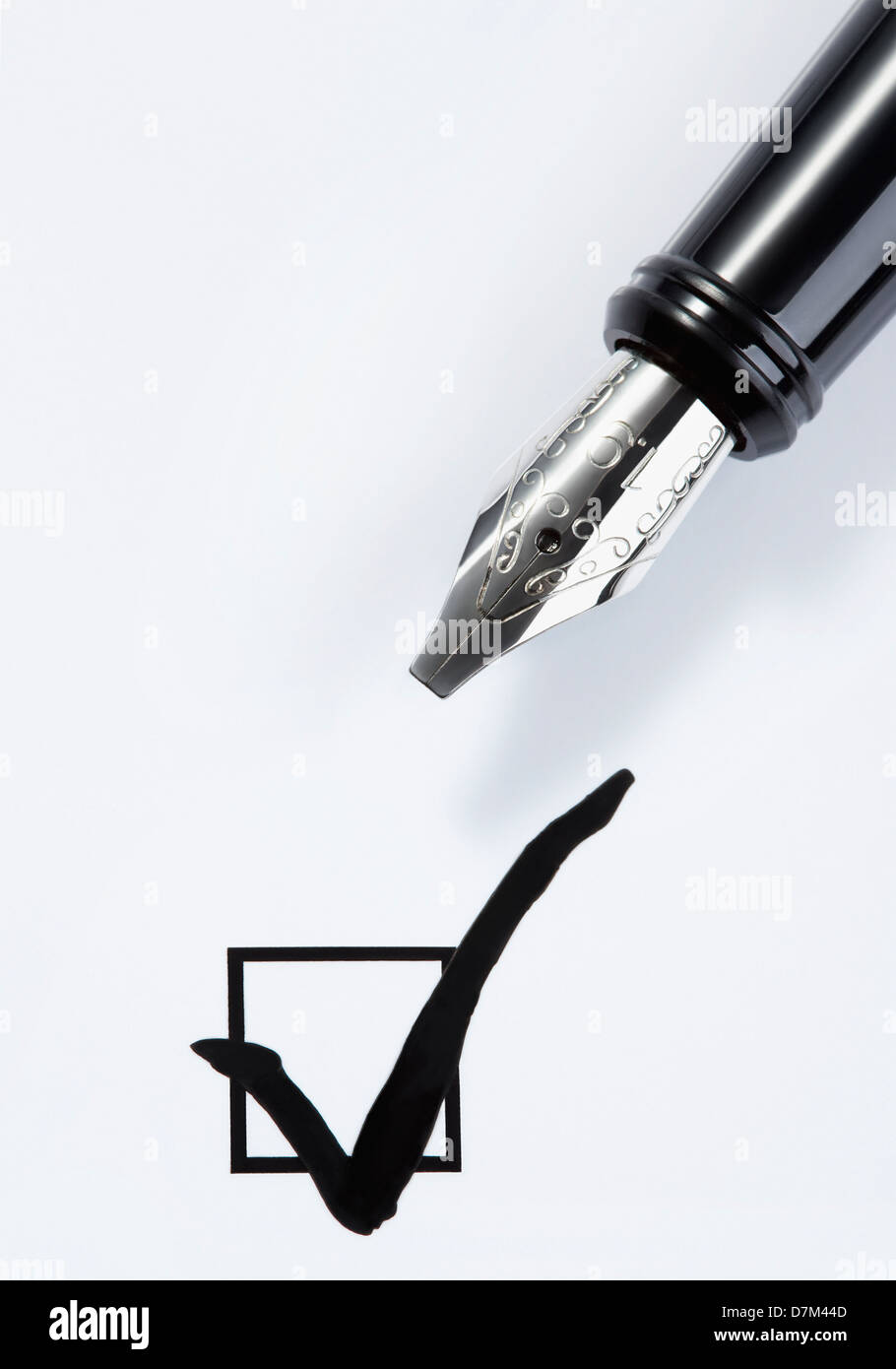 Fountain pen with check mark on white background Stock Photo - Alamy