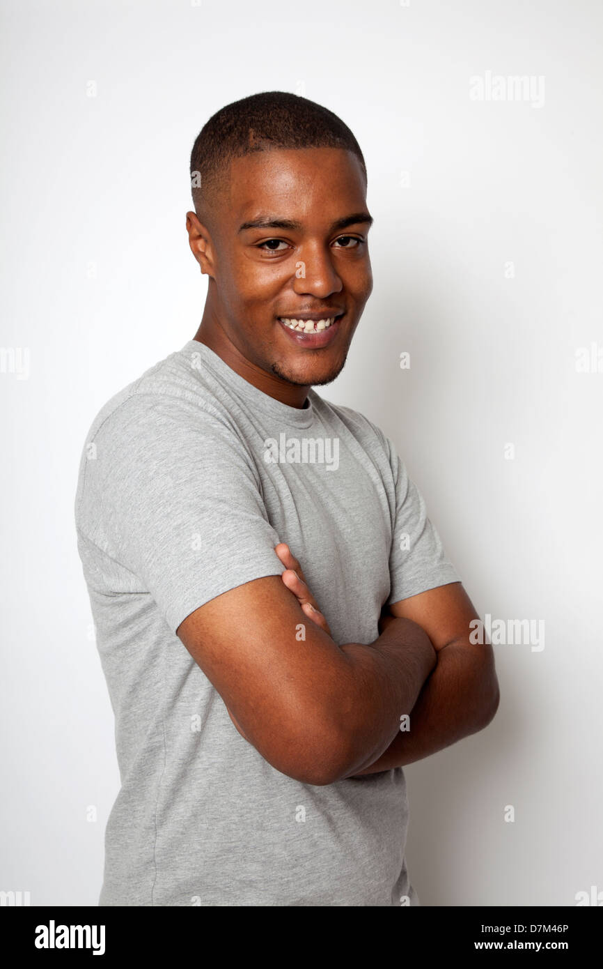Black British Male Smiling with Arms Crossed Stock Photo - Alamy