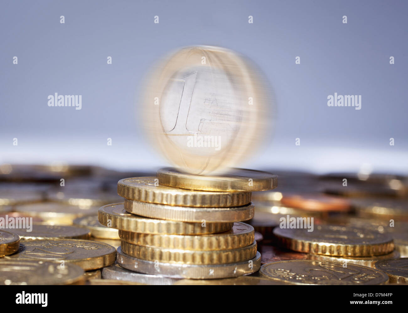 Euro coin spinning on Euro stacking Stock Photo - Alamy