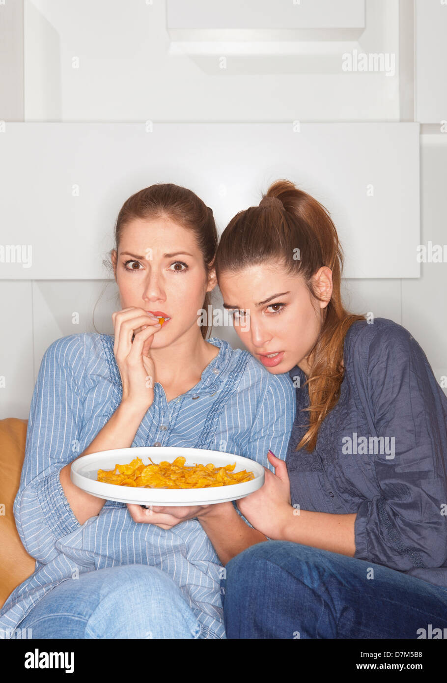 Germany, Stuttgart, Young women watching tv Stock Photo - Alamy
