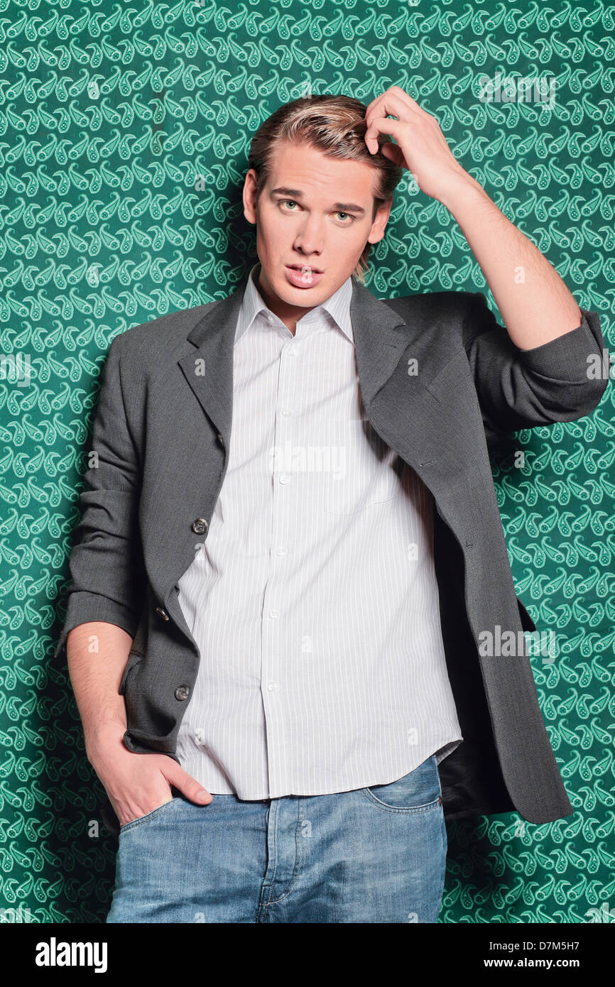 Portrait of young man scratching head Stock Photo - Alamy