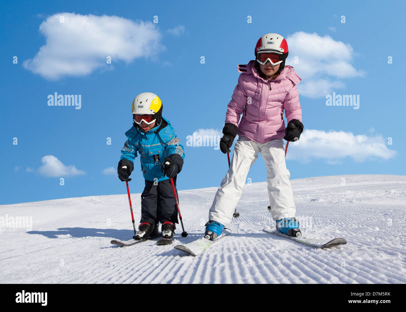 Switzerland, Boy and girl skiing in snow Stock Photo - Alamy