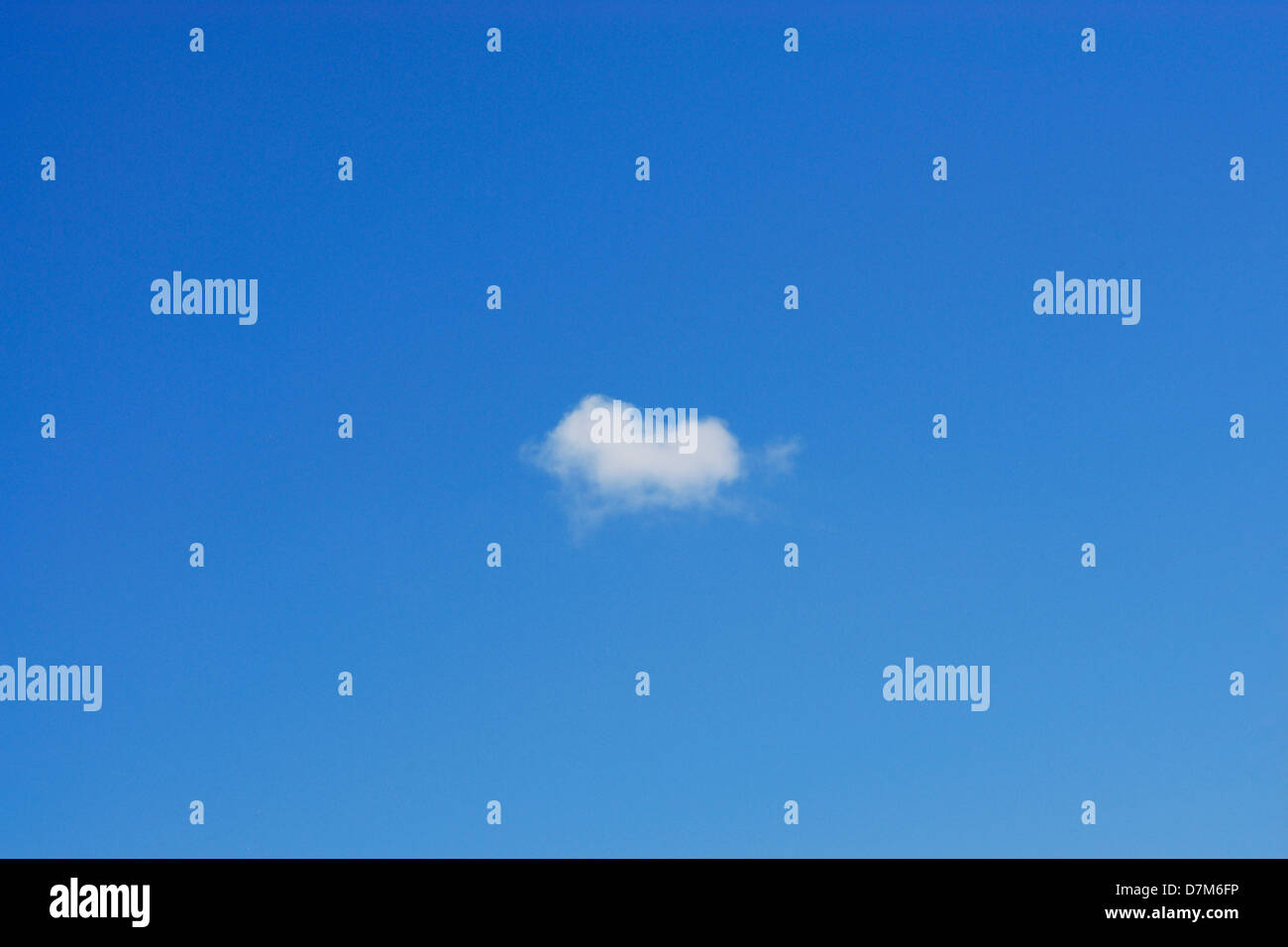 Small white fluffy cloud against a deep blue sky Stock Photo - Alamy