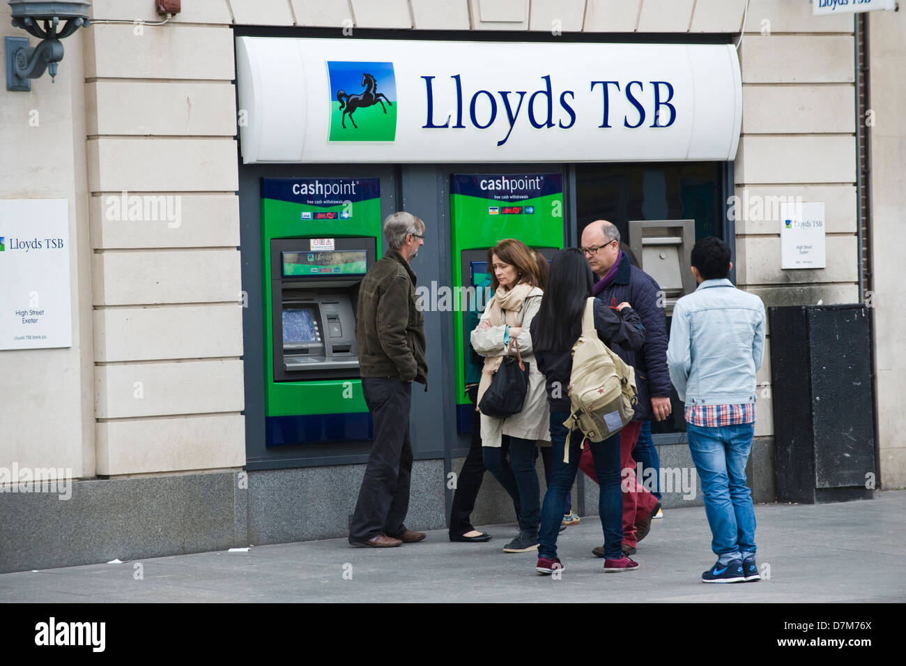Queue at LLOYDS TSB cashpoint on high street in city centre of Exeter ... Queue at LLOYDS TSB cashpoint on high street in city centre of Exeter ...