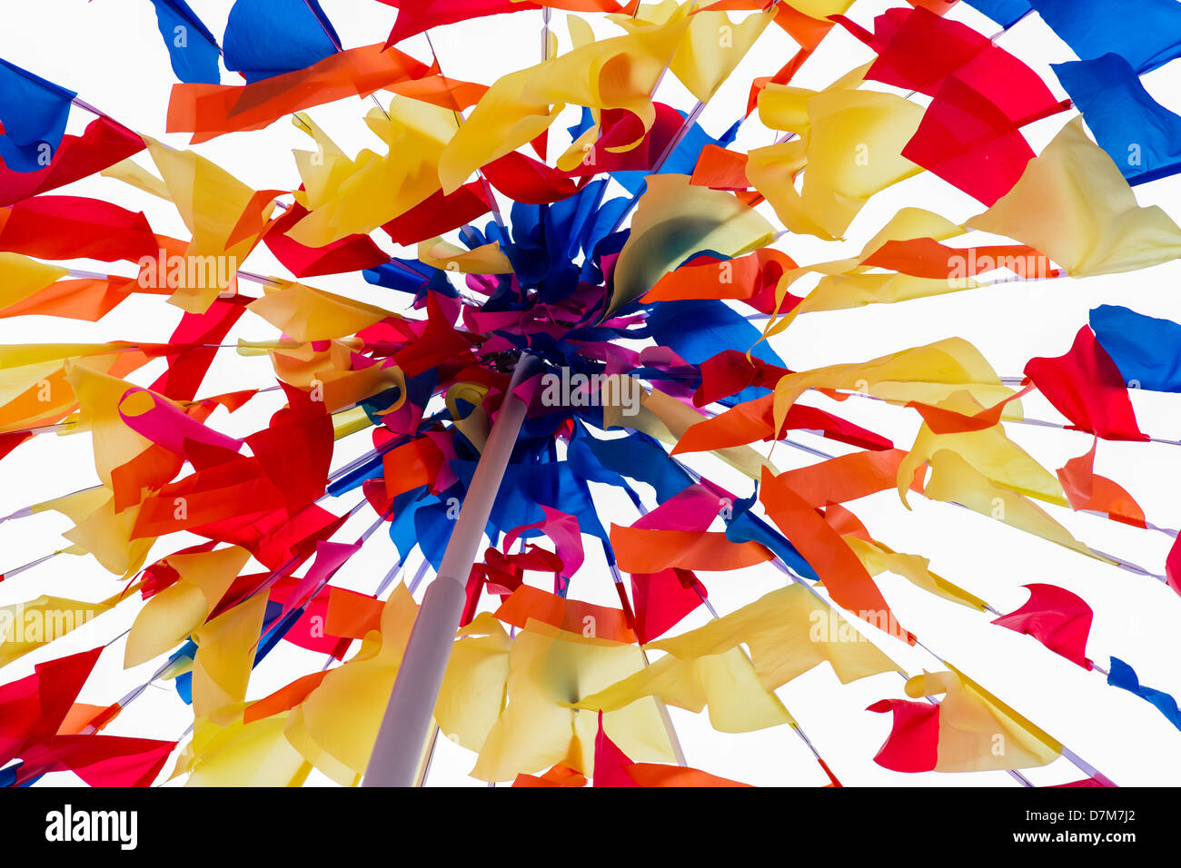 Colorful flags around a central pole, isolated Stock Photo - Alamy