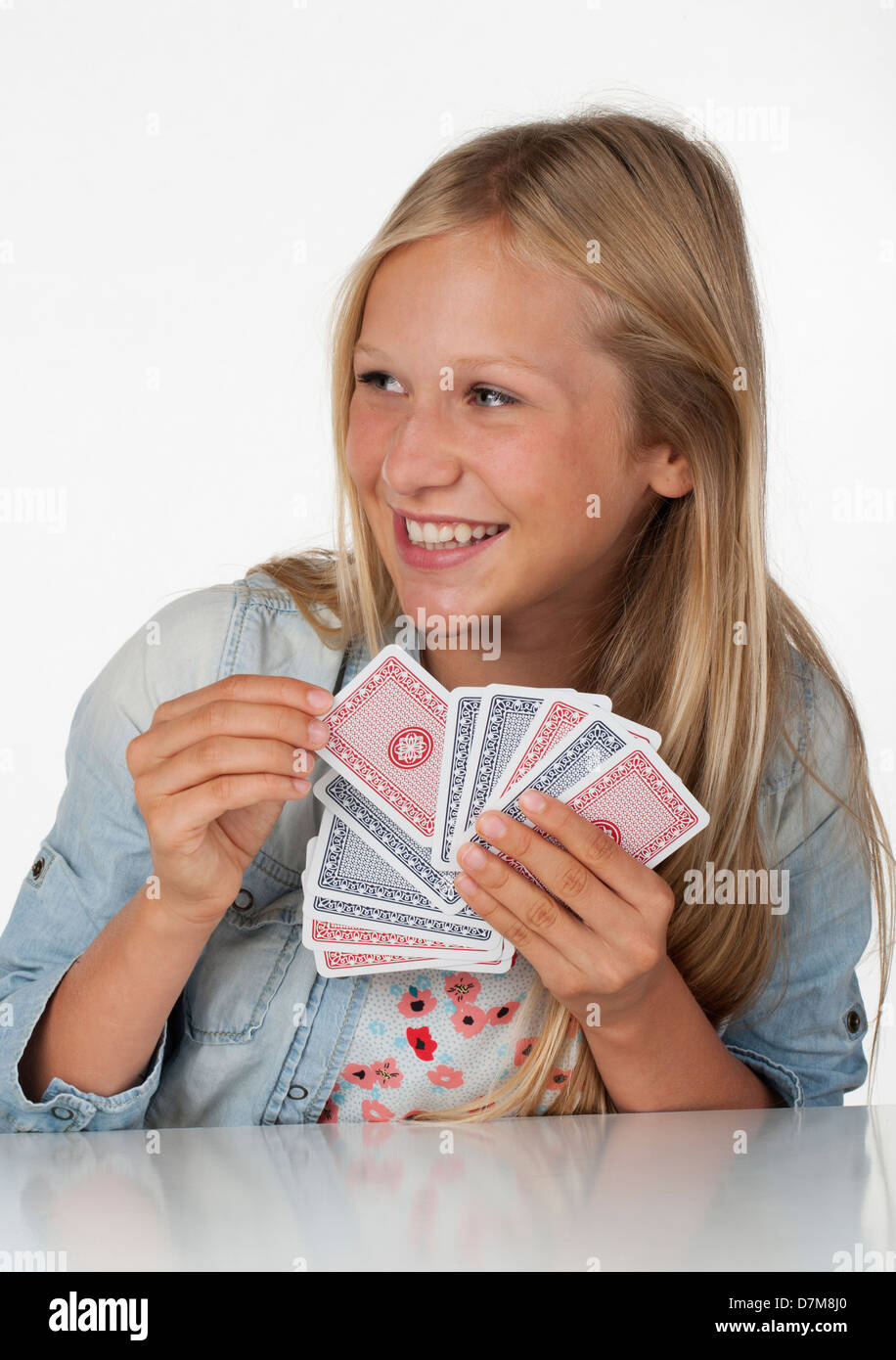 Teenage girl playing cards, smiling Stock Photo - Alamy