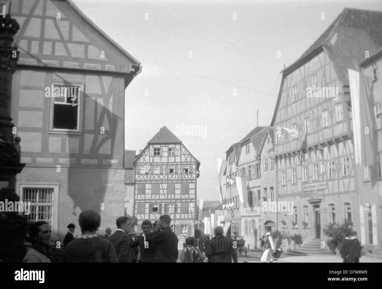 A historical photograph depicting people at Marktplatz in Mönnerstadt ...