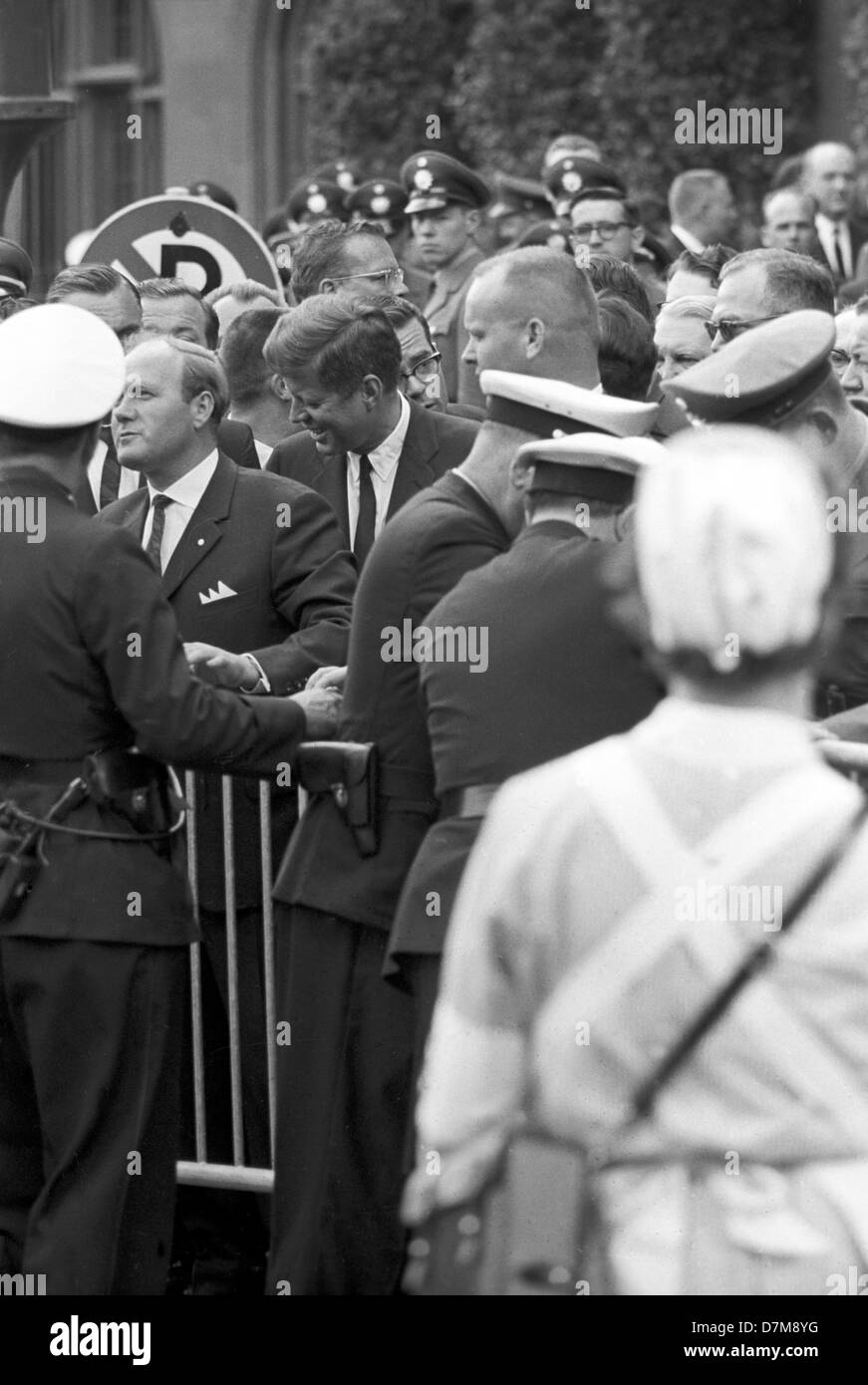 Kennedy (M) behind the barrier. US president John F. Kennedy adressed ...