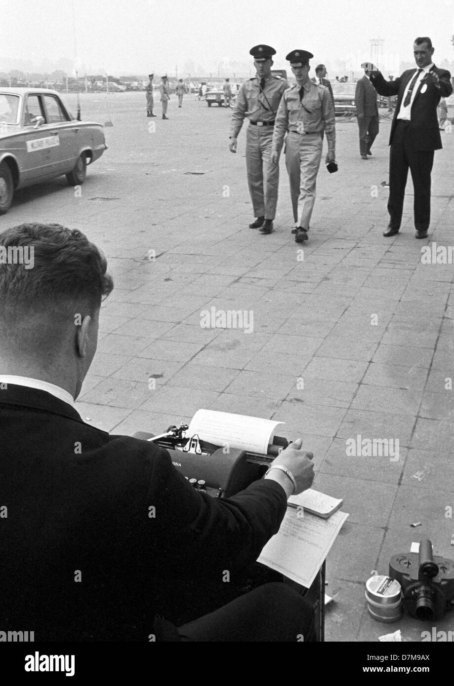 A journalist typing. US president John F. Kennedy at military air base ...