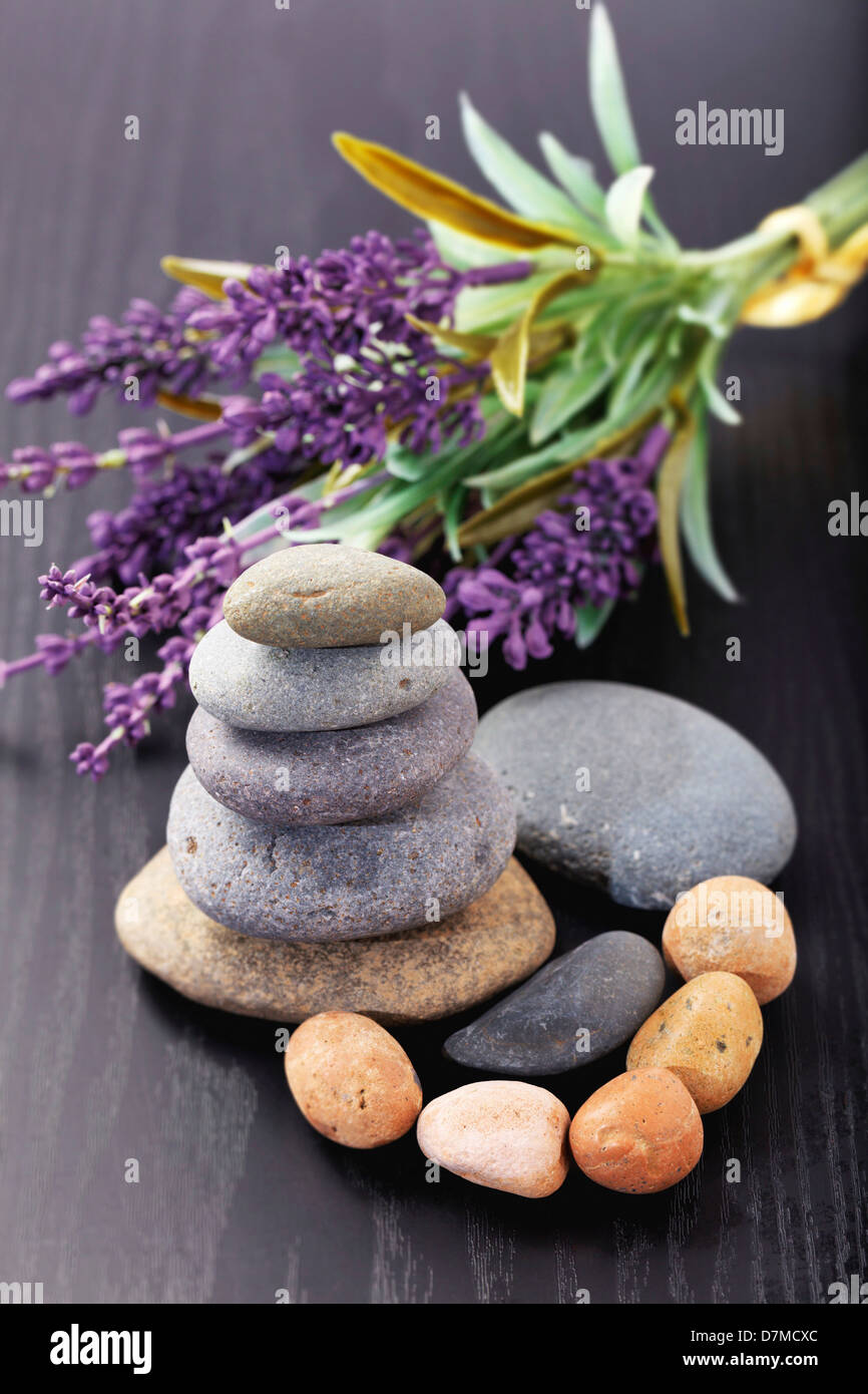 Aromatherapy, stones, oil, relaxing spa therapy over green leaf and ...