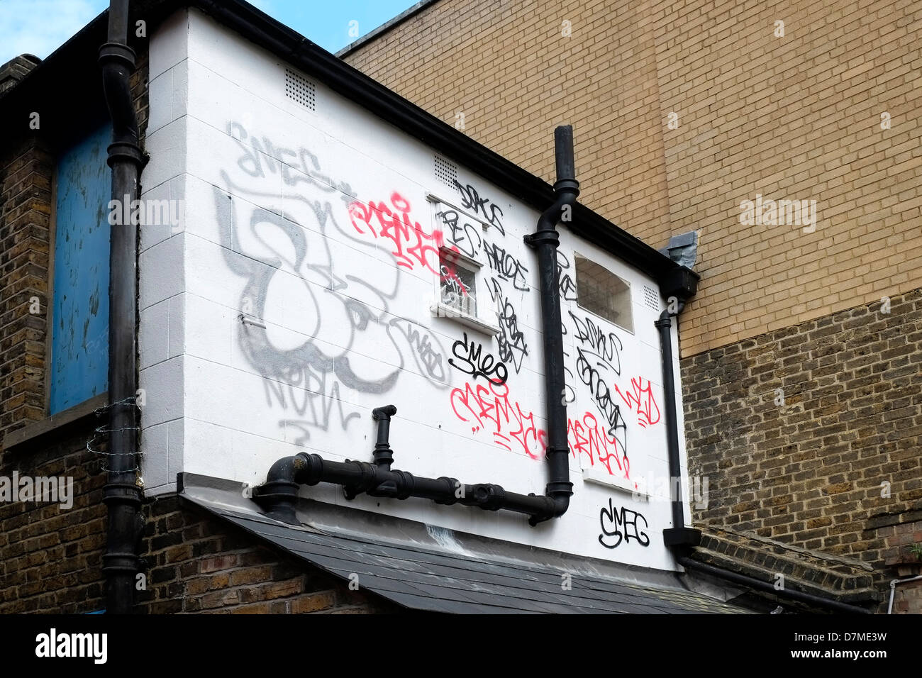The wall of a building covered in graffiti Stock Photo - Alamy