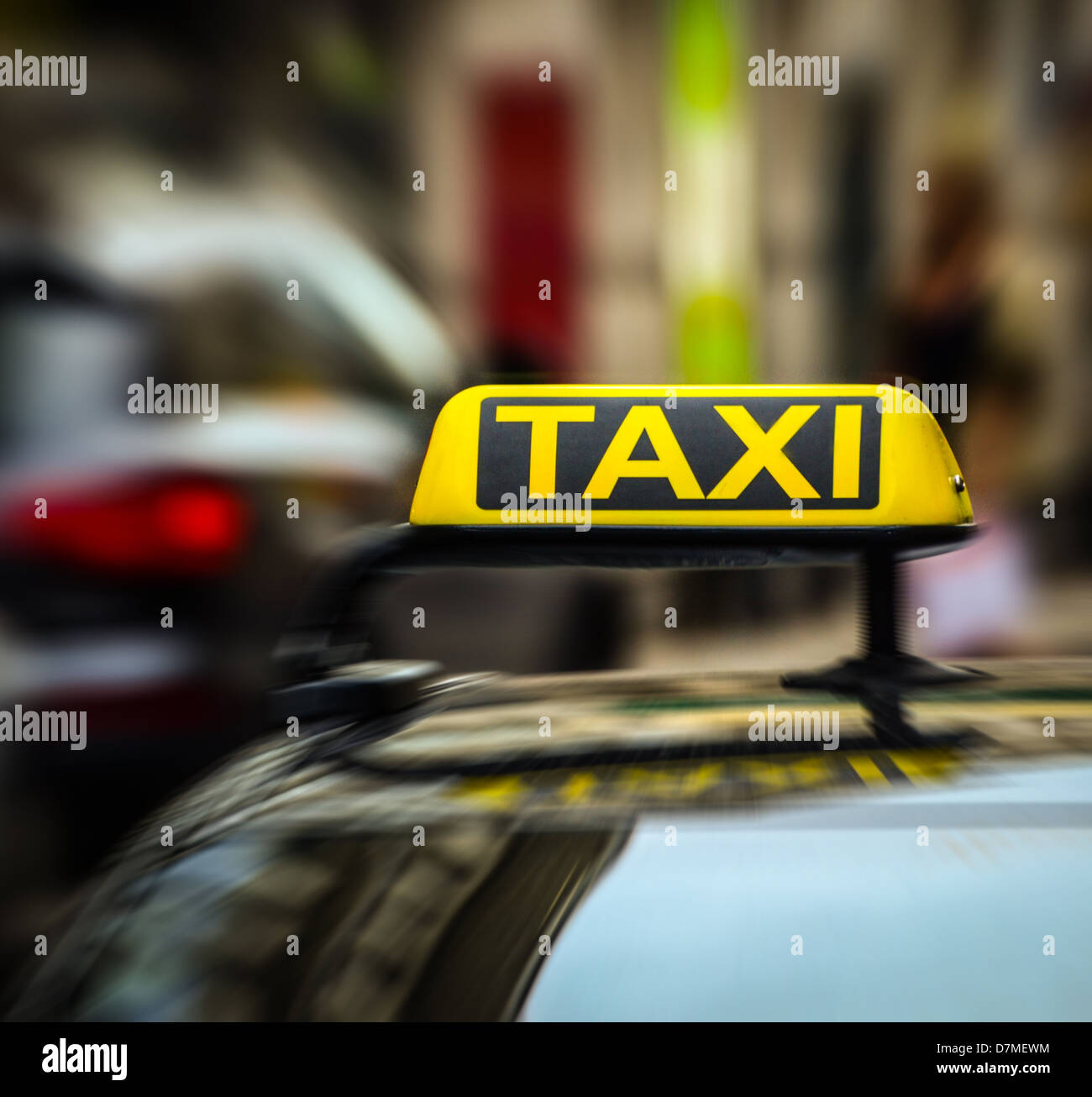 Taxi sign on car in motion blur Stock Photo - Alamy