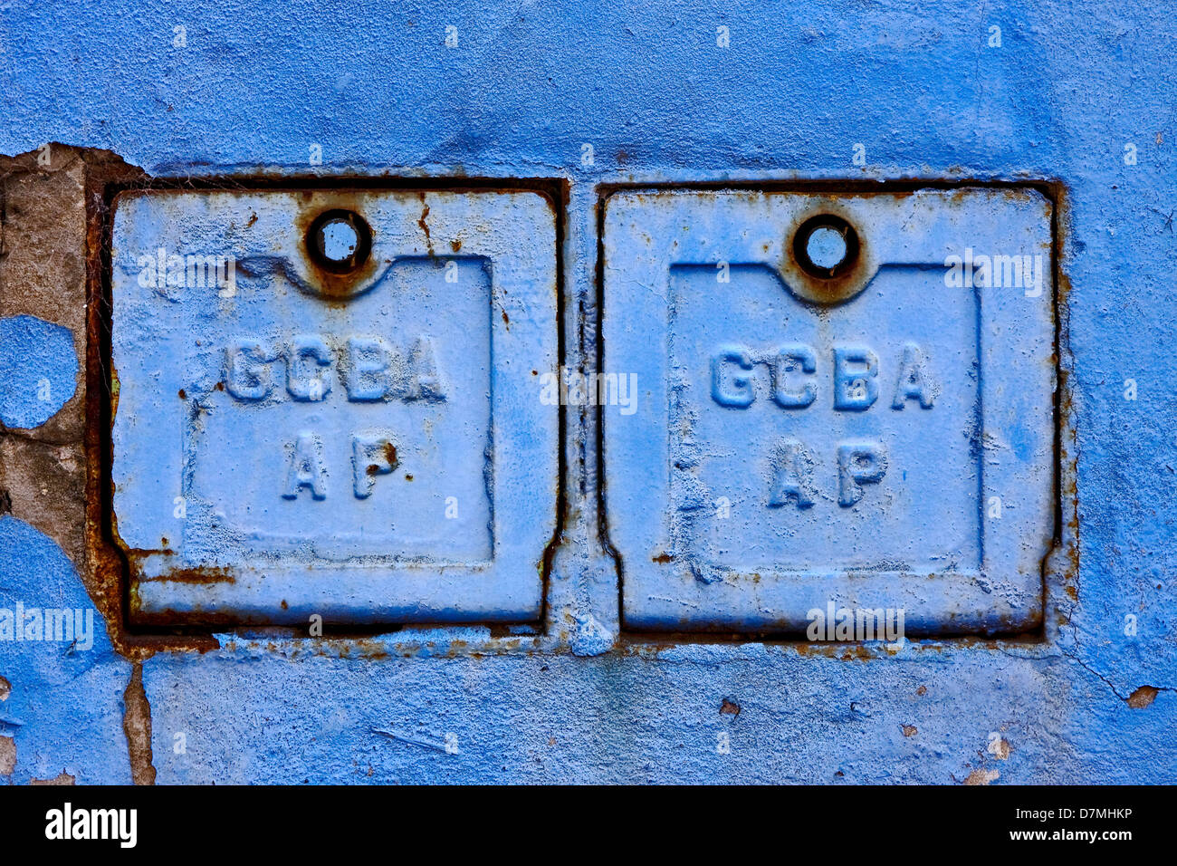 two metal box and a blue broken wall in Stock Photo - Alamy