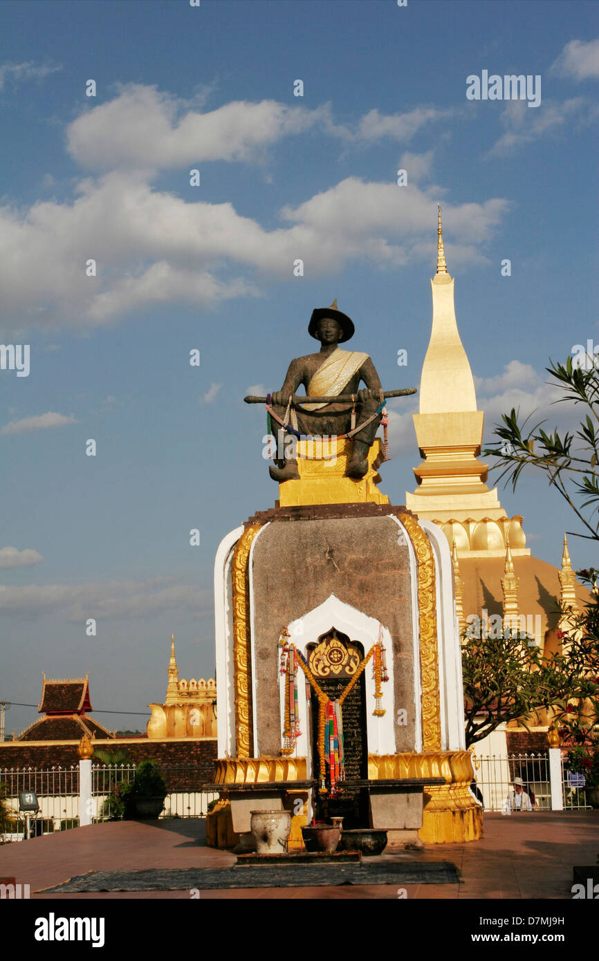 A statue of King Setthathirat in front of Pha That Luang Stock Photo ...