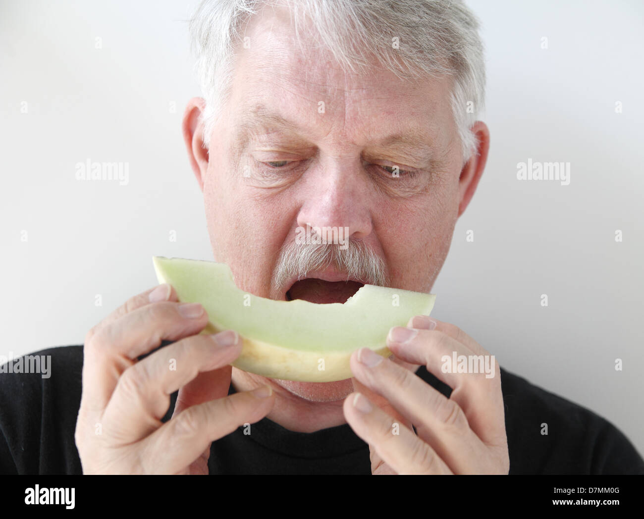 senior man set to bite into fresh fruit Stock Photo - Alamy