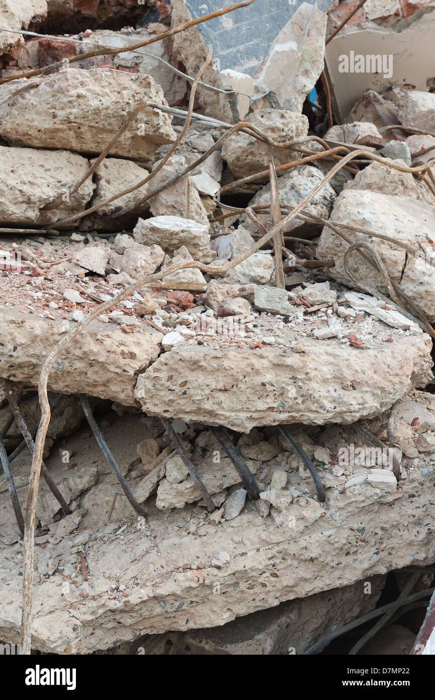 broken reinforced concrete with reinforcing iron steel frame is piled ...