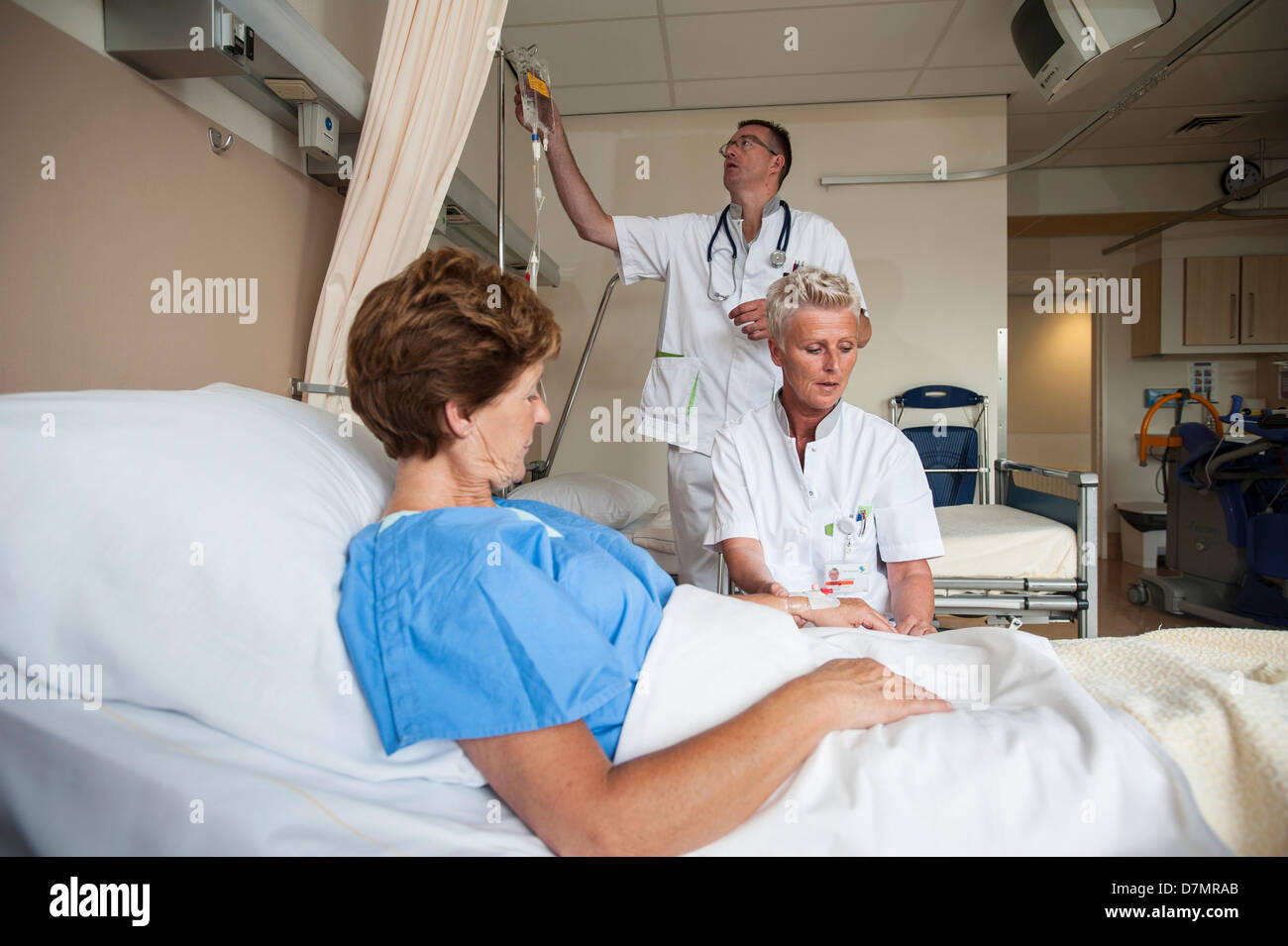 Nurses preparing a patient for an IV line Stock Photo - Alamy
